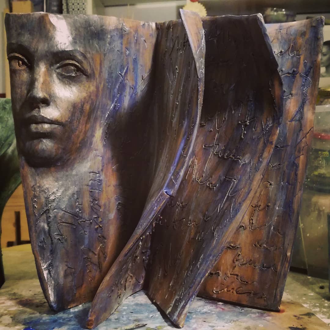 These Bronze Book Sculptures Have Placid Faces Emerging From its Pages ...